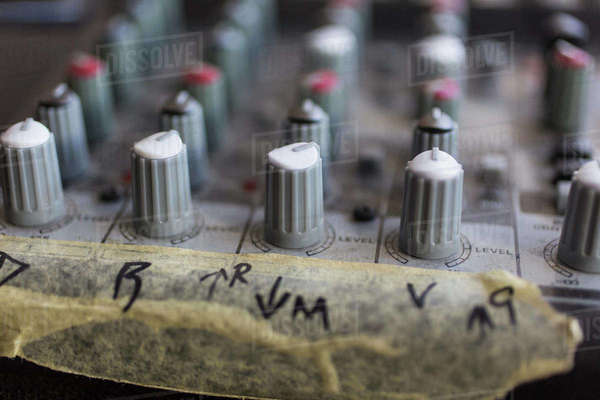 Close up sound mixer dials with taped markings - Stock Photo - Dissolve