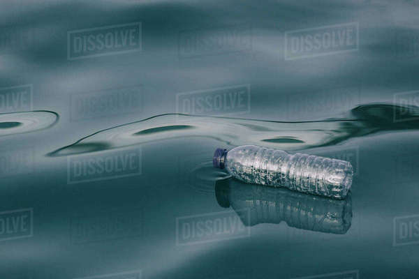 Plastic water bottle floating on water surface - Royalty-free Stock ...