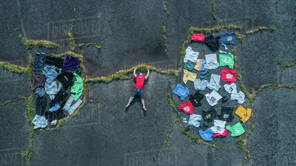 Knolling man holding up crack connecting clothing wardrobe - Stock ...
