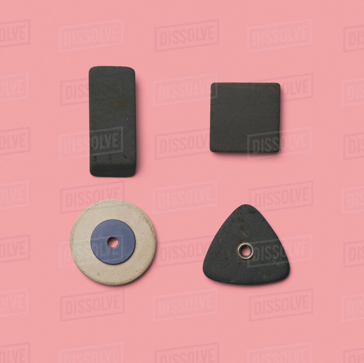 Rubber pieces in various shapes on pink background - Stock Photo - Dissolve