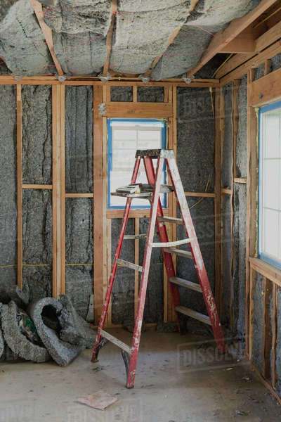 Ladder and insulation in house under construction - Stock Photo - Dissolve