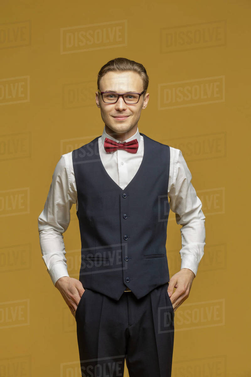 Studio portrait handsome young man in suit and bow tie - Royalty-free ...