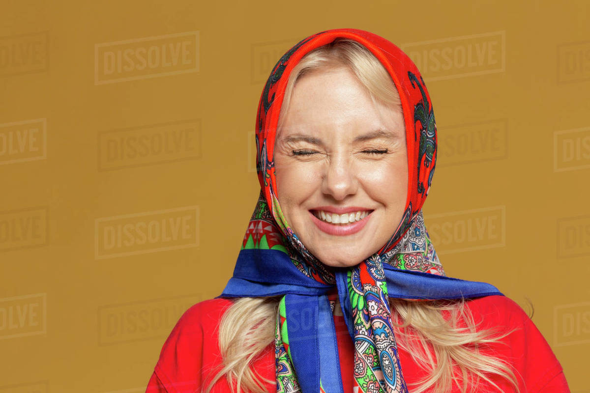 Portrait carefree woman in colorful babushka headscarf - Stock Photo ...