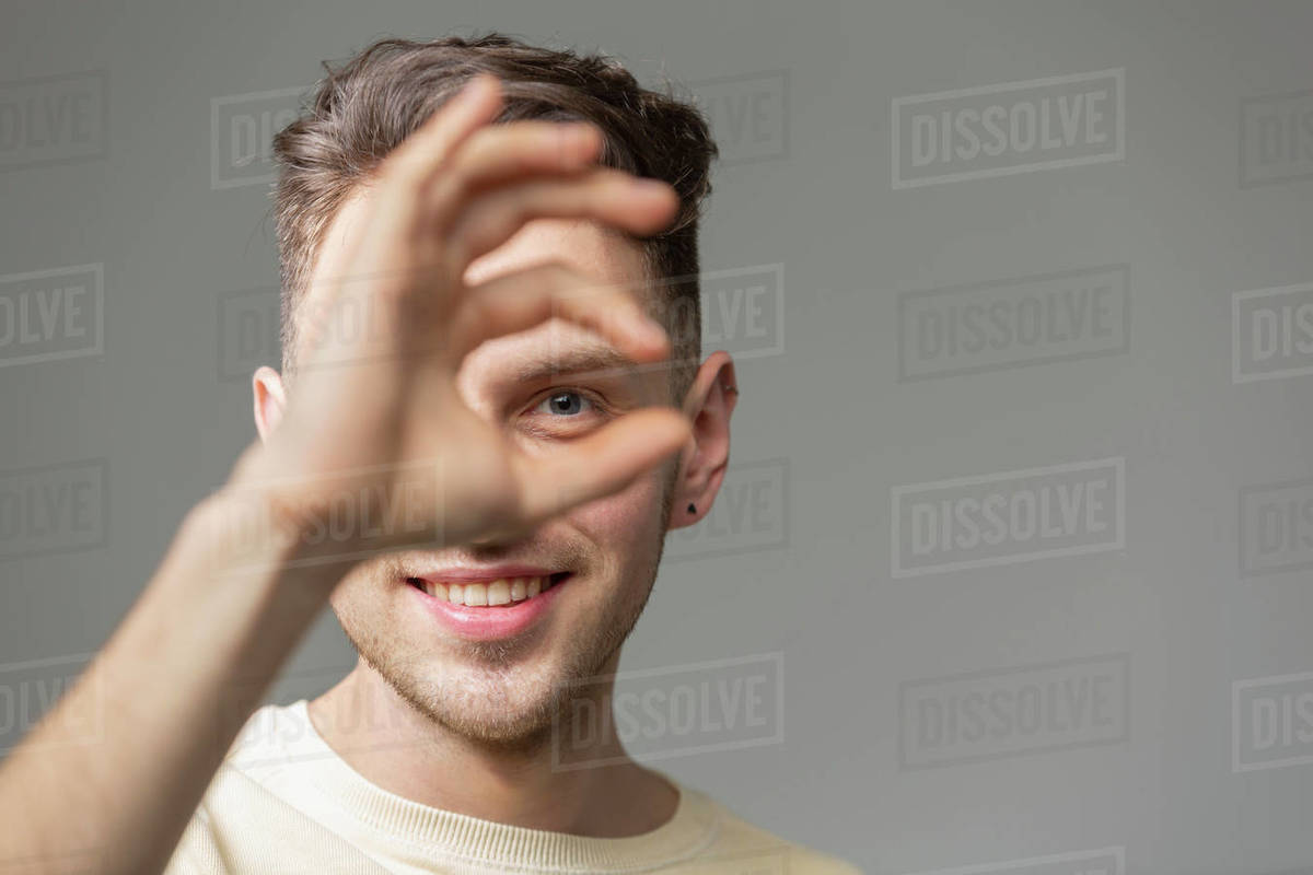 Young man gesturing - Royalty-free Stock Photo | Dissolve