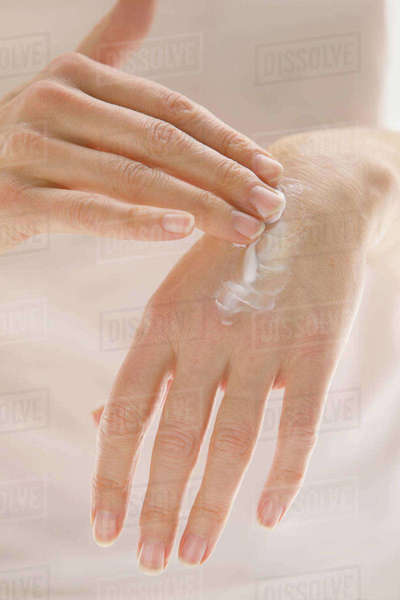 Woman Applying Hand Lotion, Close up view - Stock Photo - Dissolve