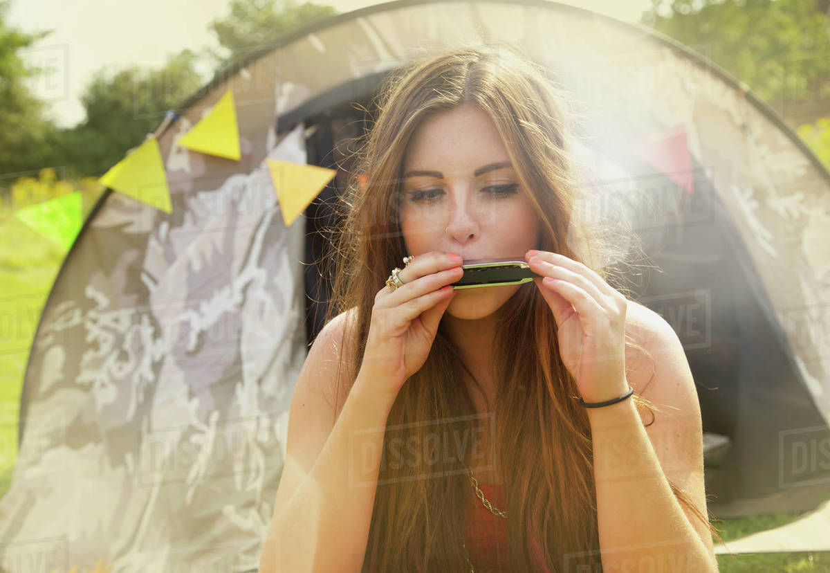 Teenage Girl Playing Harmonica - Royalty-free Stock Photo | Dissolve