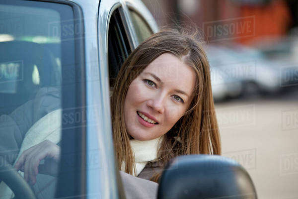 Woman driver with head out of window - Royalty-free Stock Photo | Dissolve