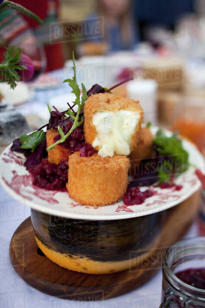 Fried camembert on plate on dining table outside - Royalty-free Stock ...