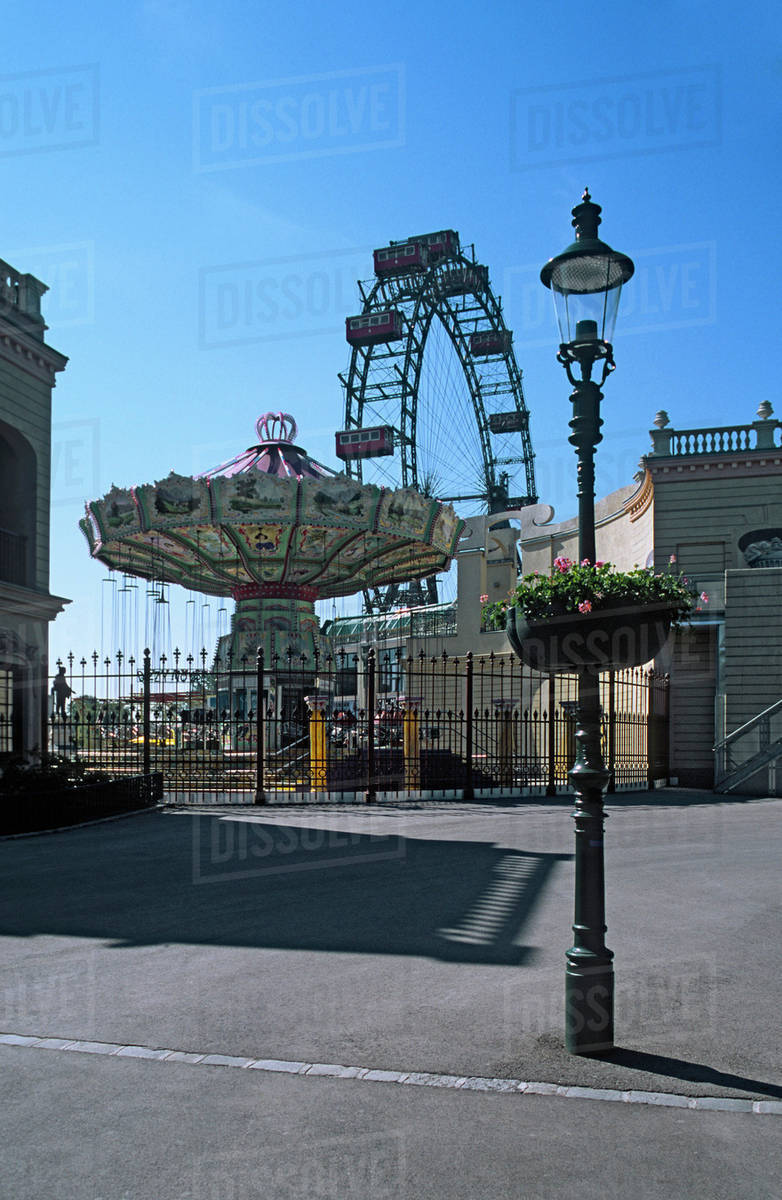 Austria, Vienna, Prater park amusement park rides with lamp post in ...