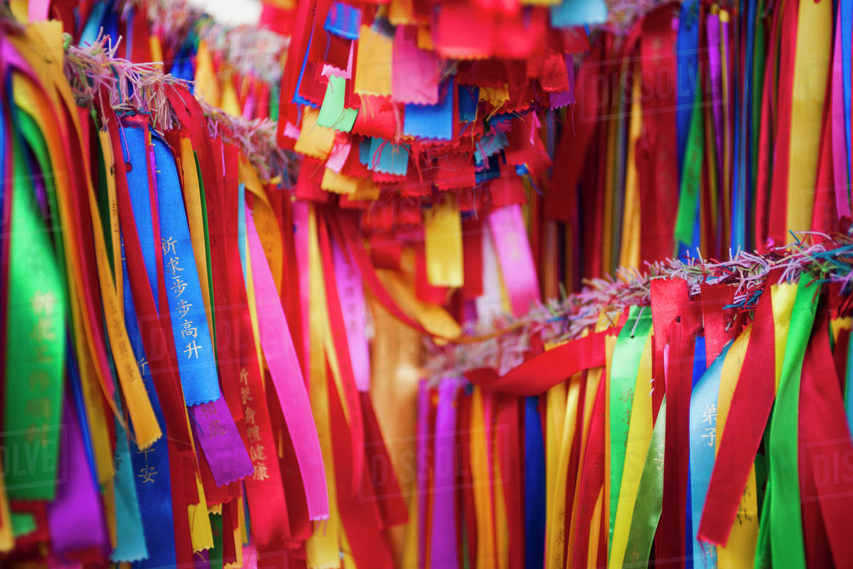 Detail of colored prayer ribbons - Stock Photo - Dissolve